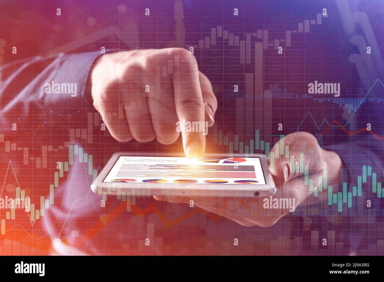 Male economist with tablet computer using virtual screen with diagrams ...