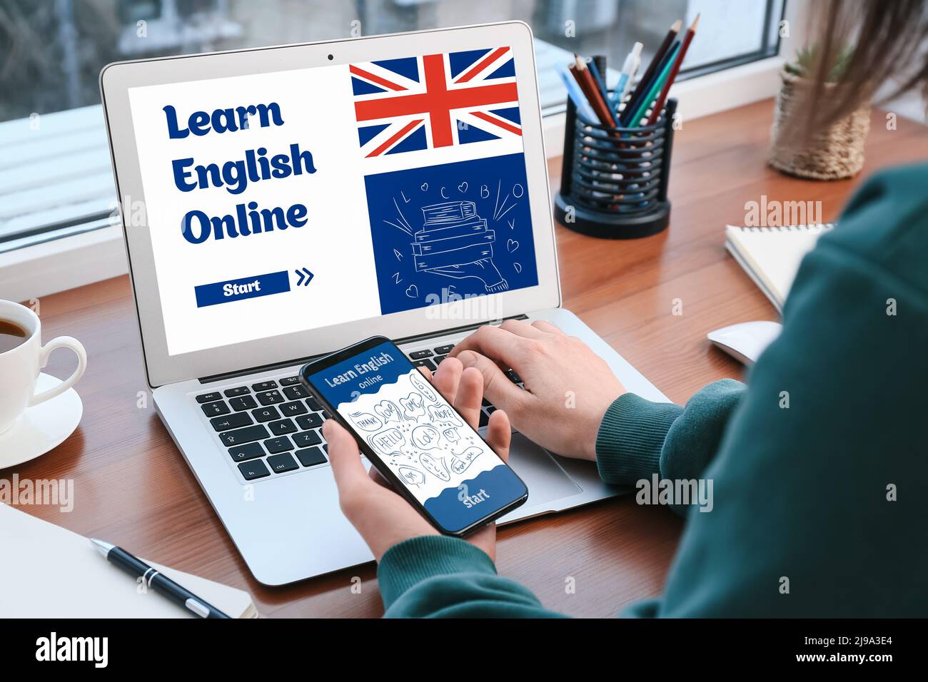 Young woman studying English online at home Stock Photo - Alamy