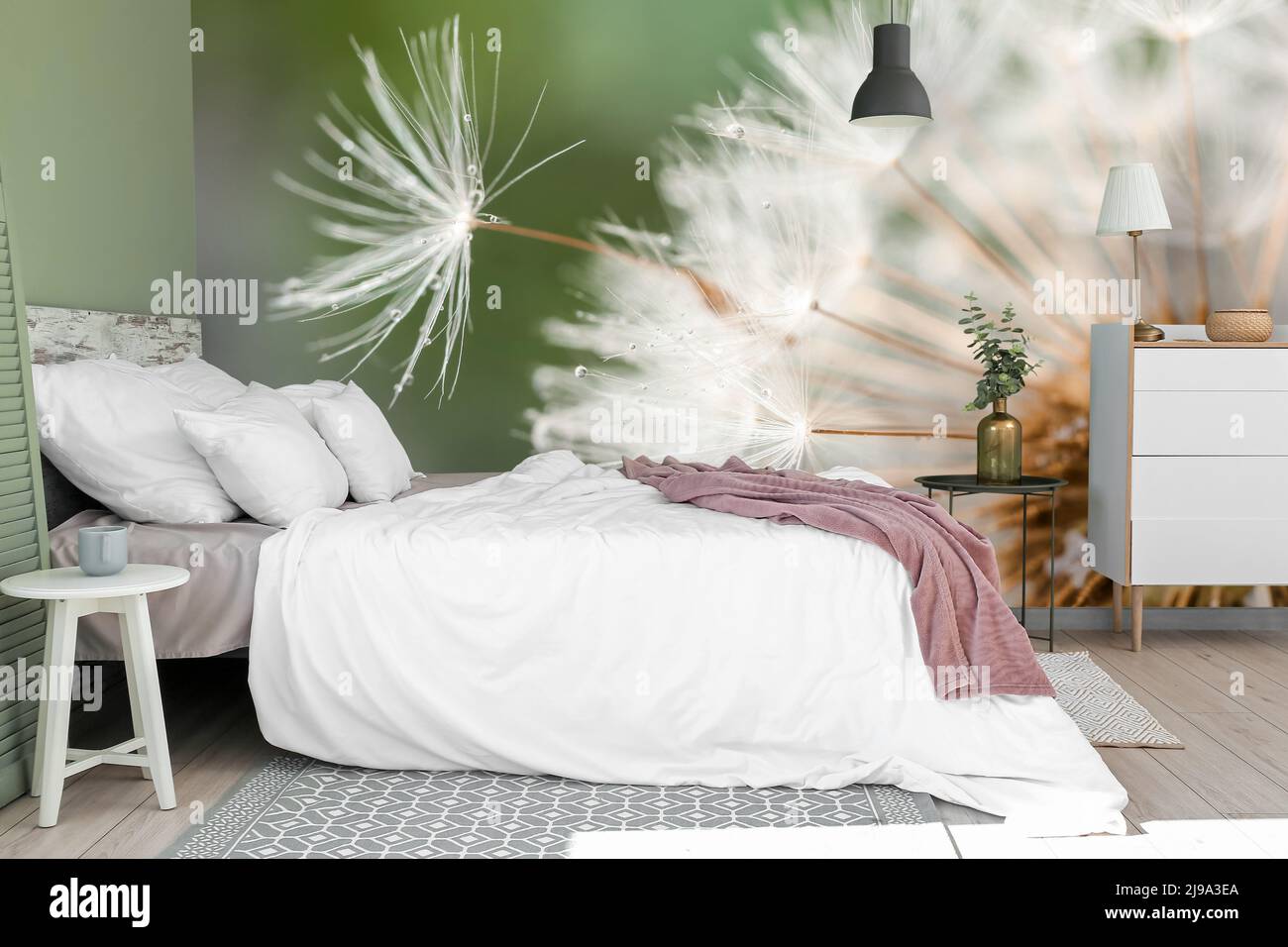 Stylish interior of cozy bedroom with printed blowball on wall Stock ...