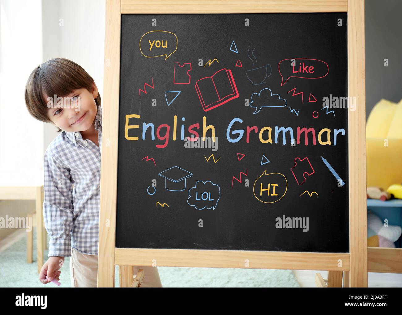 Cute little boy near chalkboard with text ENGLISH GRAMMAR Stock Photo ...