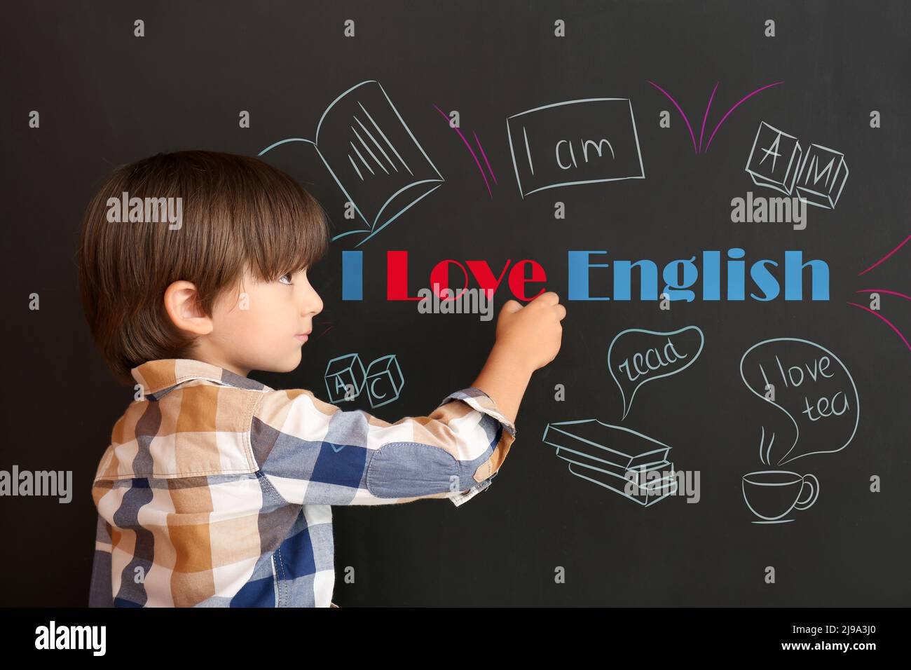 Cute little boy writing text I LOVE ENGLISH on blackboard Stock Photo ...