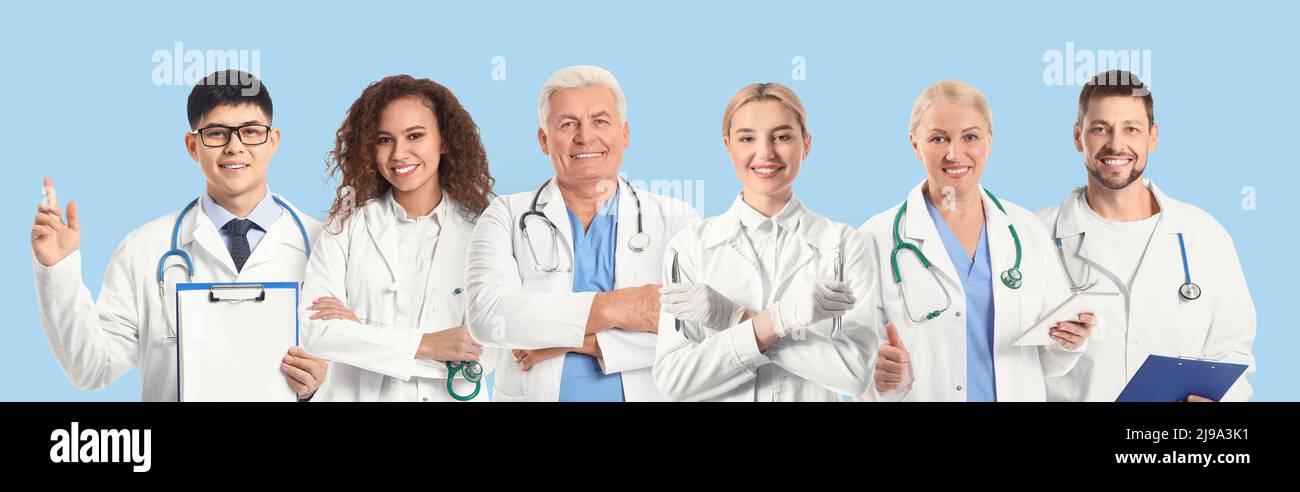 Many different doctors on light blue background Stock Photo - Alamy