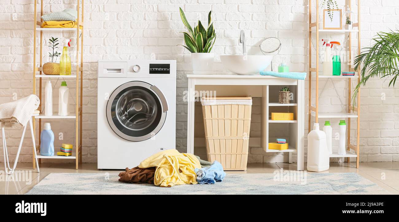 Washing machine in interior of light laundry room Stock Photo - Alamy