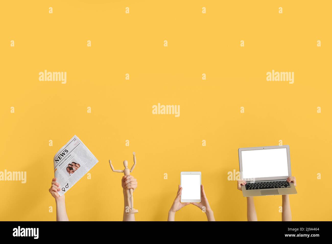 People with newspaper, gadgets and wooden mannequin on yellow ...
