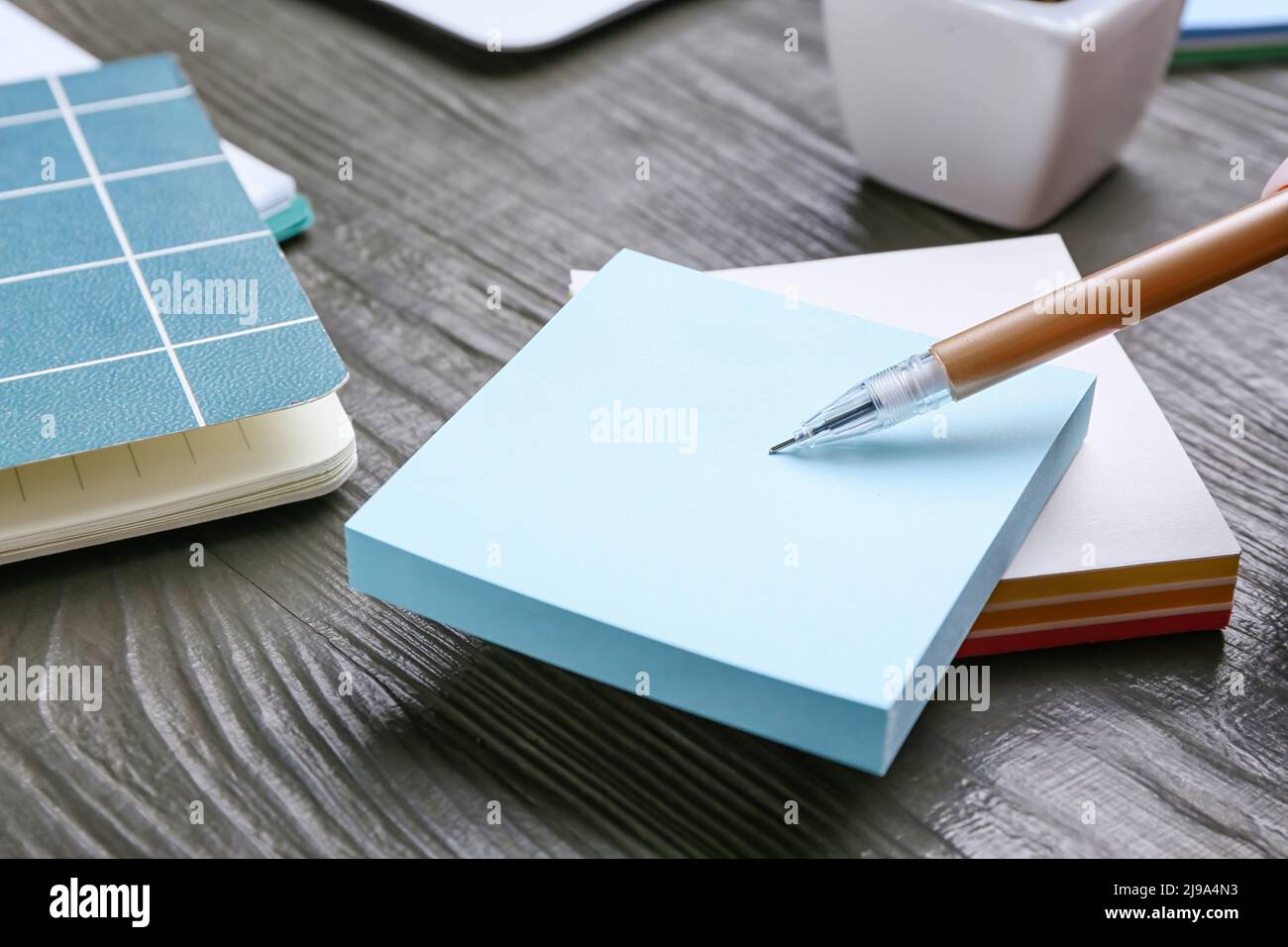 Stack of blank sticky notes and pen on grey wooden table, closeup Stock ...