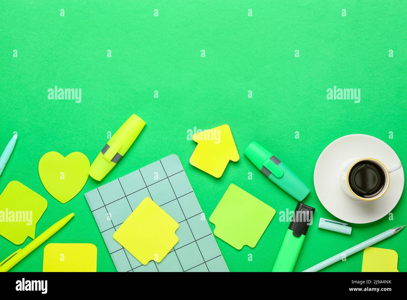 Different sticky notes, notebook, markers, pens and cup of coffee on ...