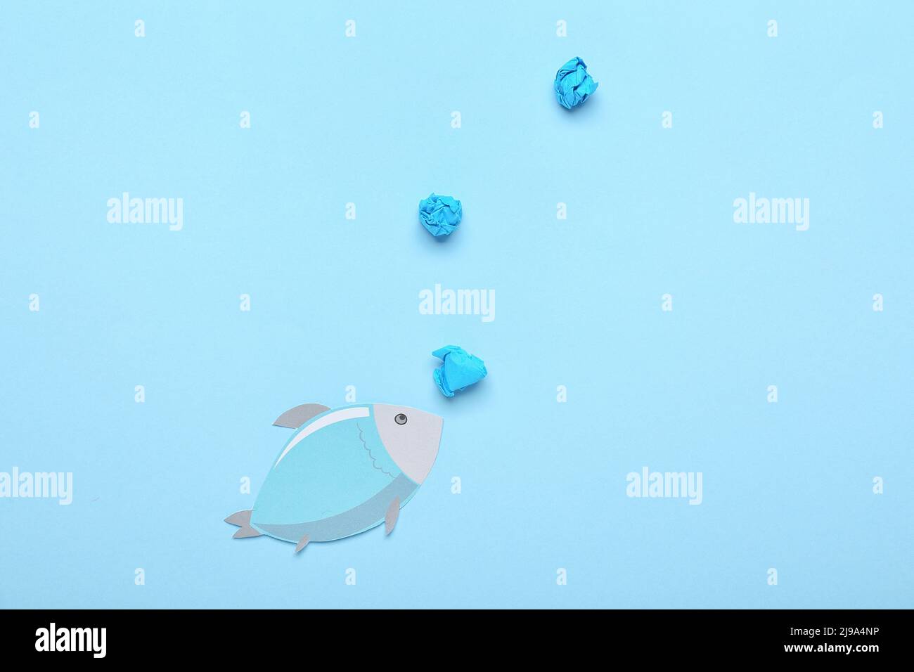 Paper fish and bubbles made of crumpled sticky notes on blue background ...