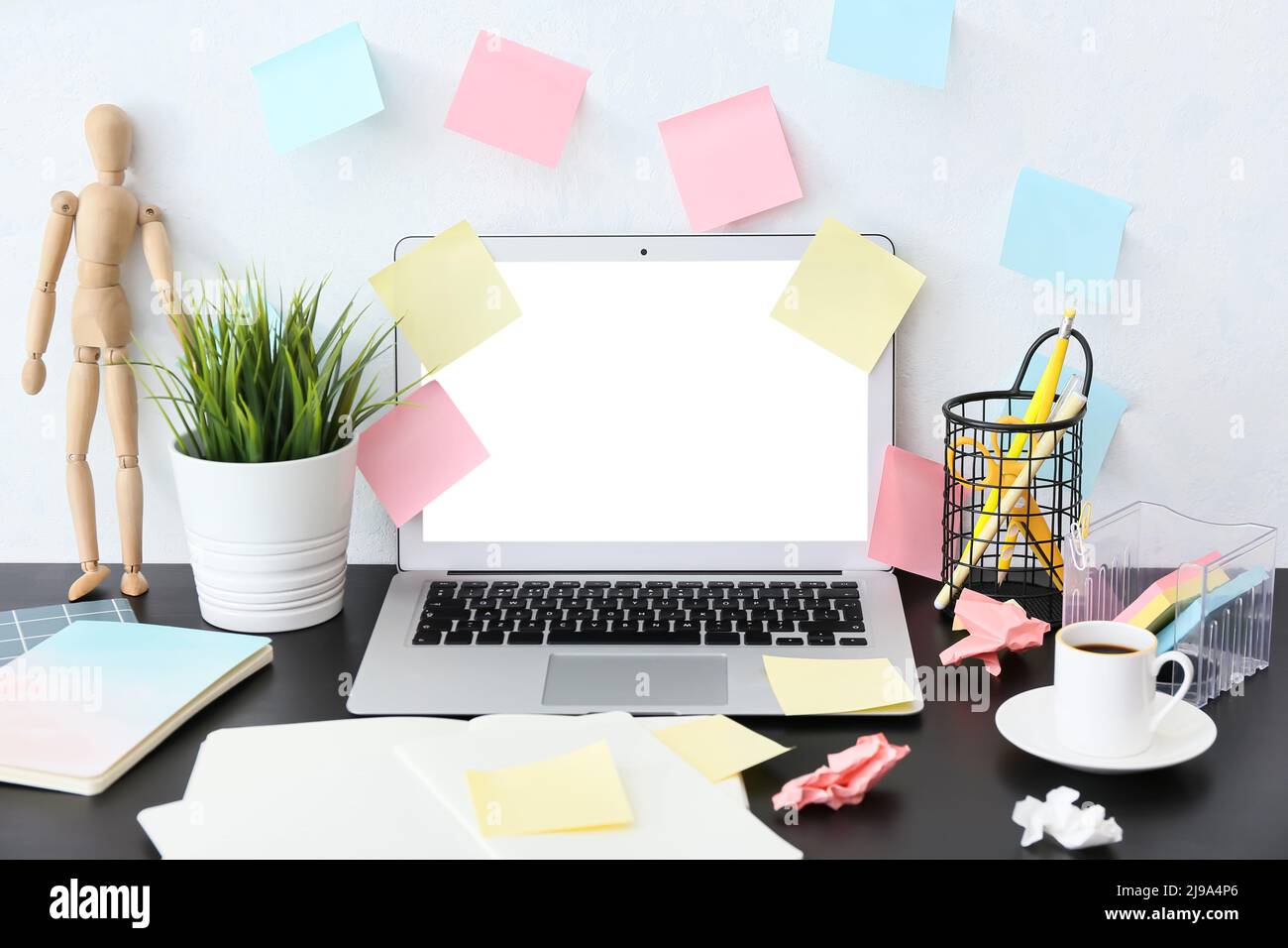 Workplace with different sticky notes, laptop, stationery supplies and ...