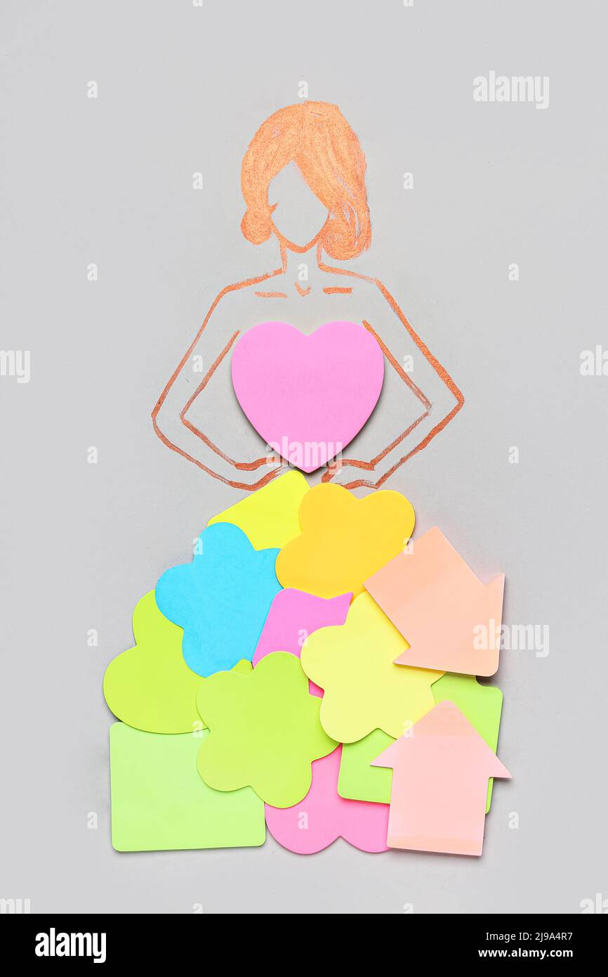 Silhouette of woman with dress made of sticky notes on grey background ...