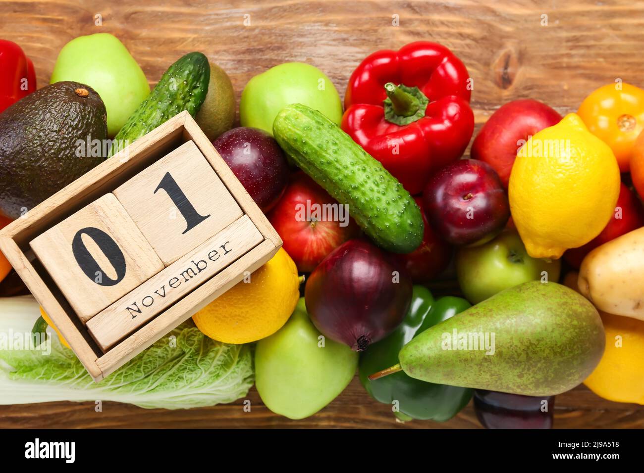 Cube calendar with date NOVEMBER 1, vegetables and fruits on wooden ...
