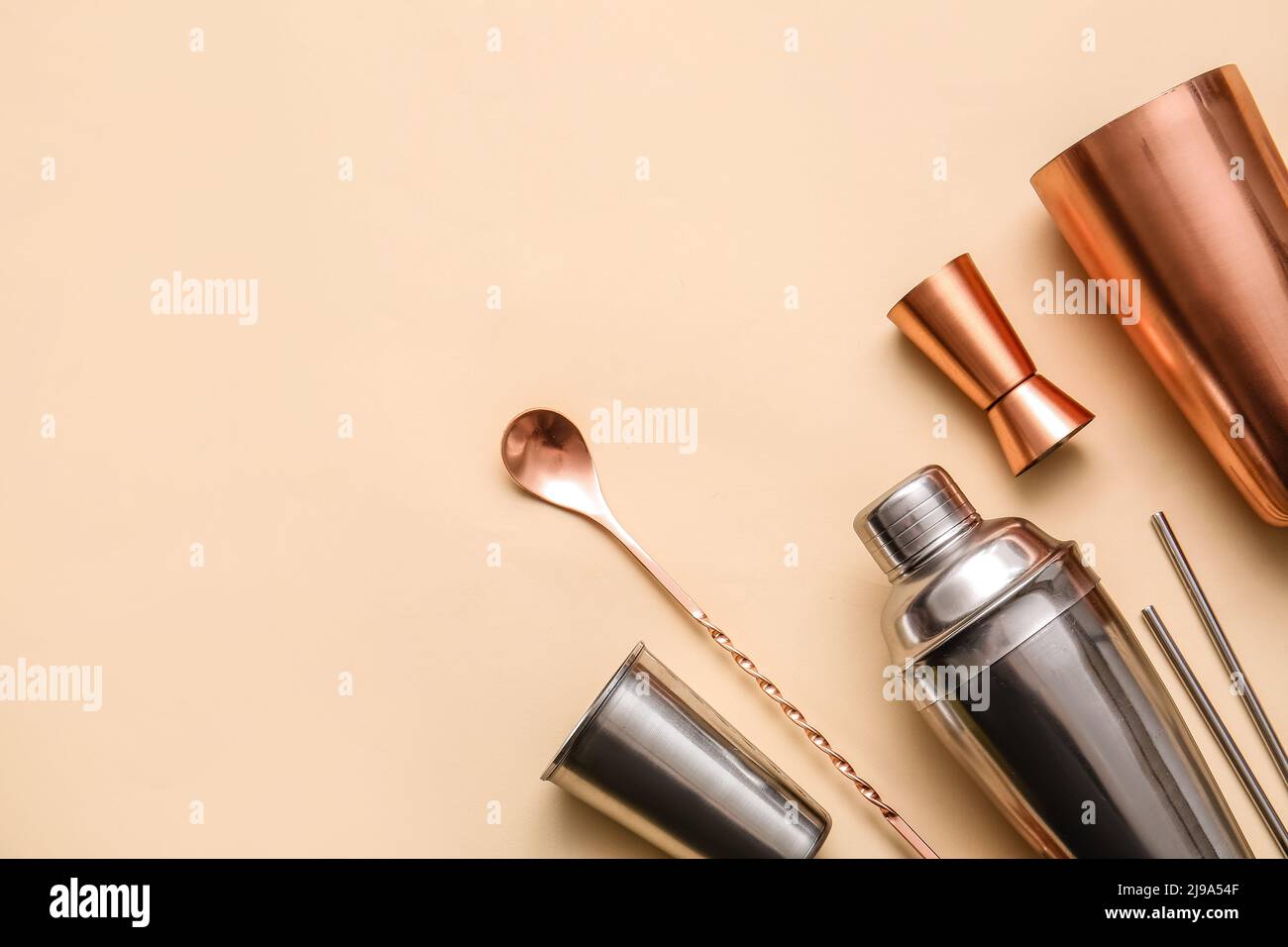 Copper and silver cocktail utensils on color background, closeup Stock ...