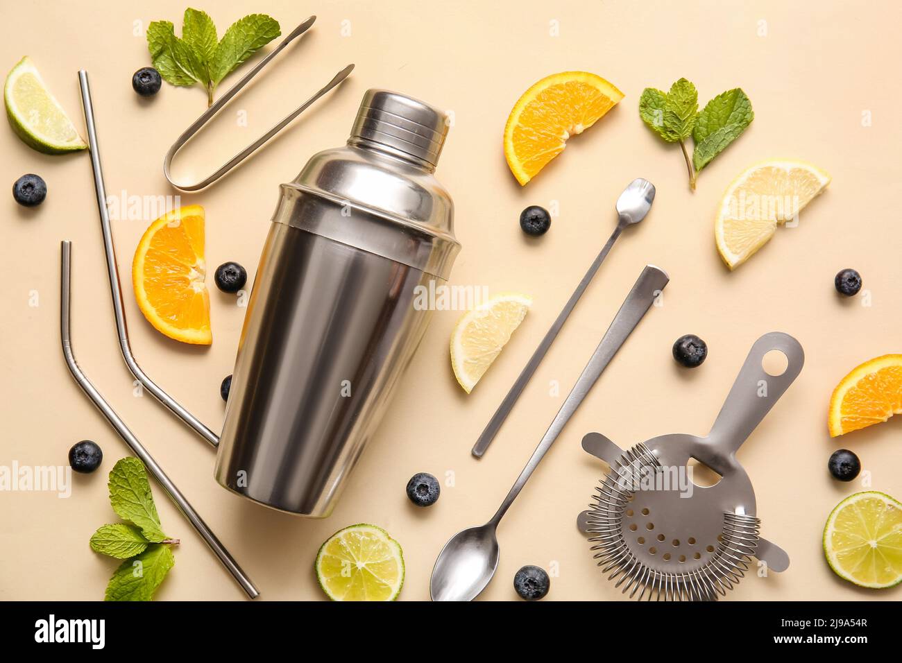 Modern bartender kit and cocktail ingredients on color background Stock ...