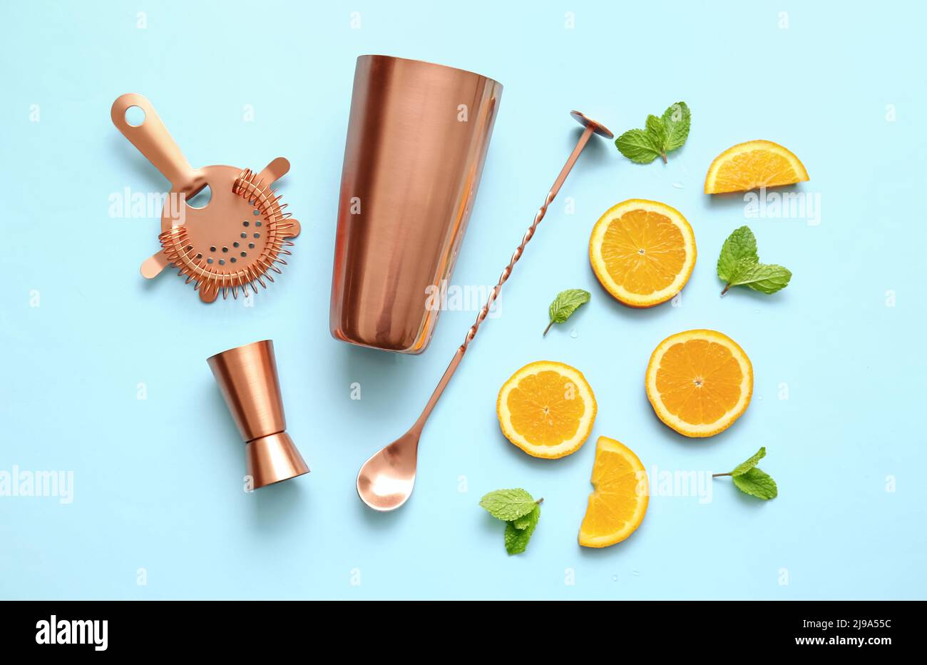 Copper bartender tools and ingredients on blue background Stock Photo ...