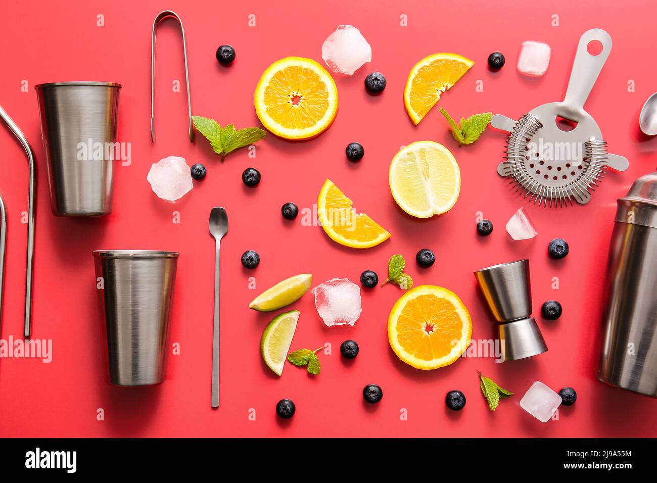 Cocktail ingredients and different utensils on red background Stock ...
