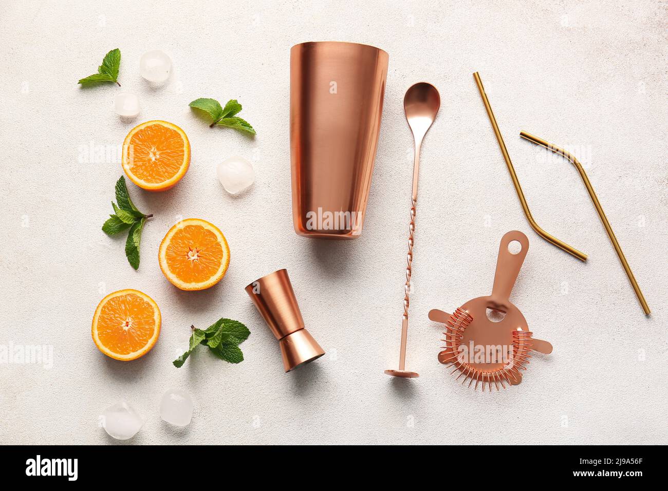 Copper cocktail utensils and ingredients on light background Stock ...