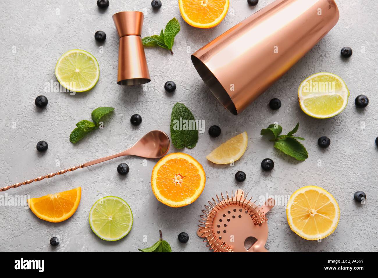 Cocktail utensils and ingredients on grey background Stock Photo - Alamy
