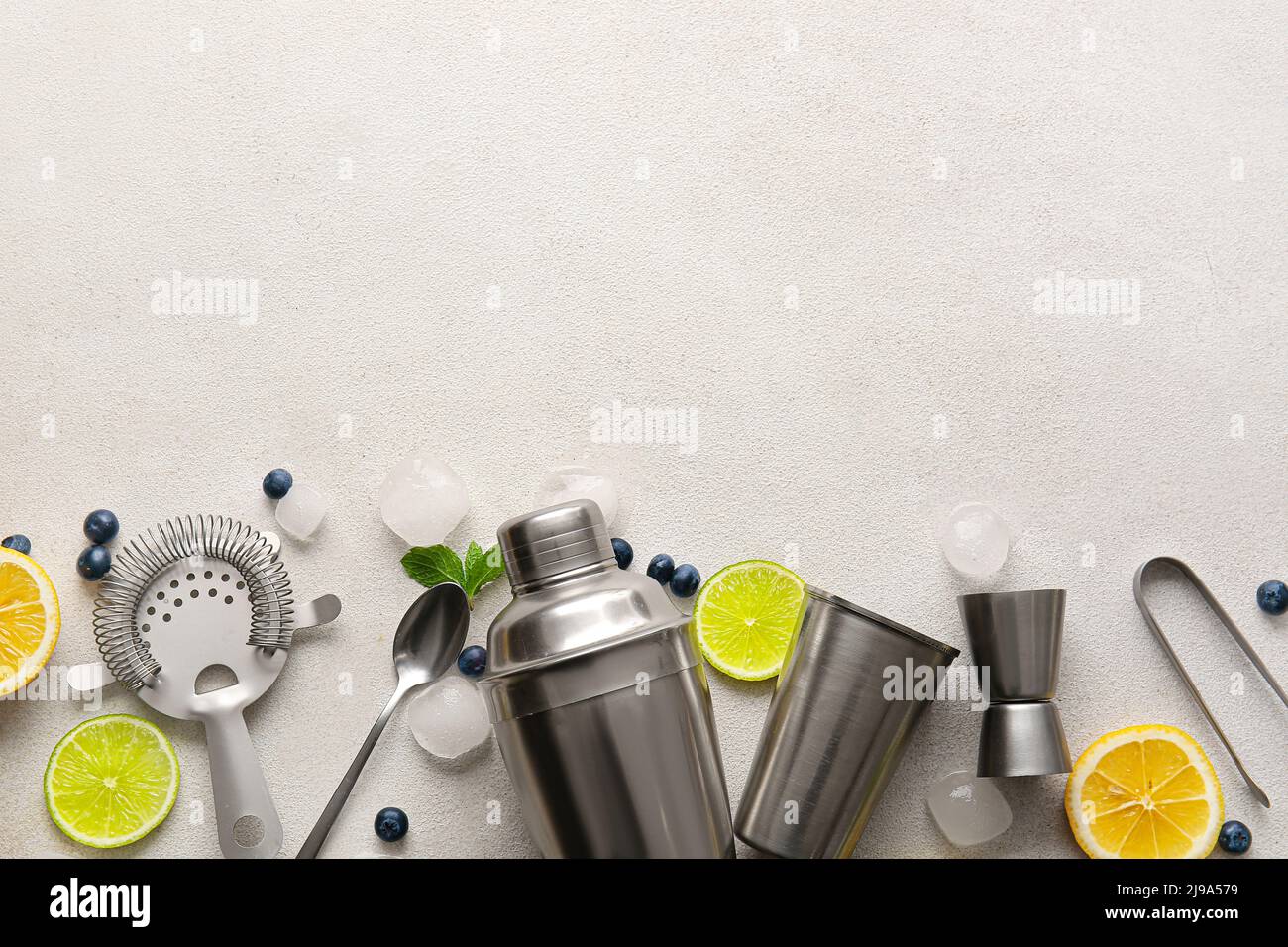 Set of bartender utensils and cocktail ingredients on light background ...