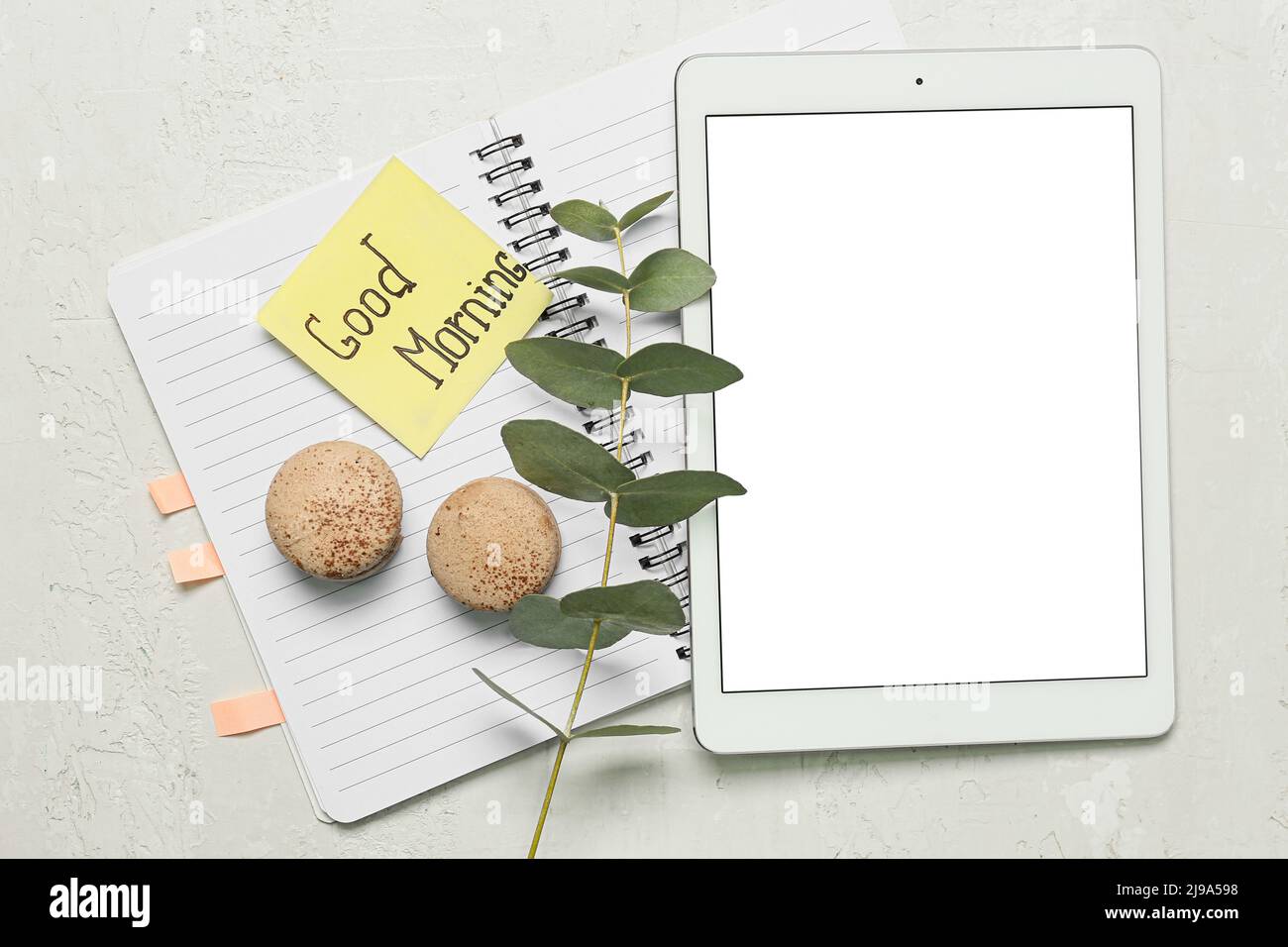 Composition with tablet computer, macaroons and sticky note with text ...