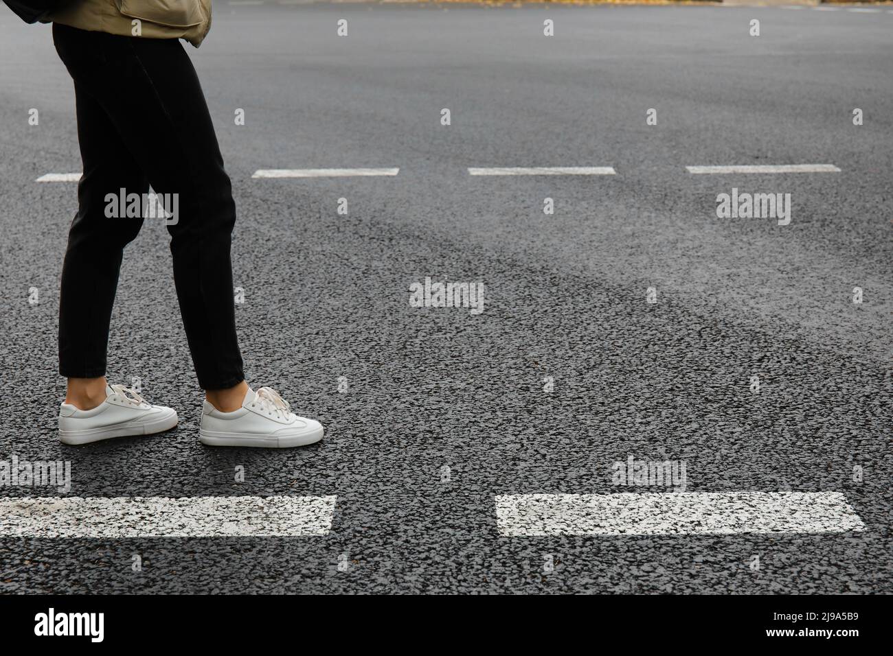 Woman on zebra crossing hi-res stock photography and images - Alamy