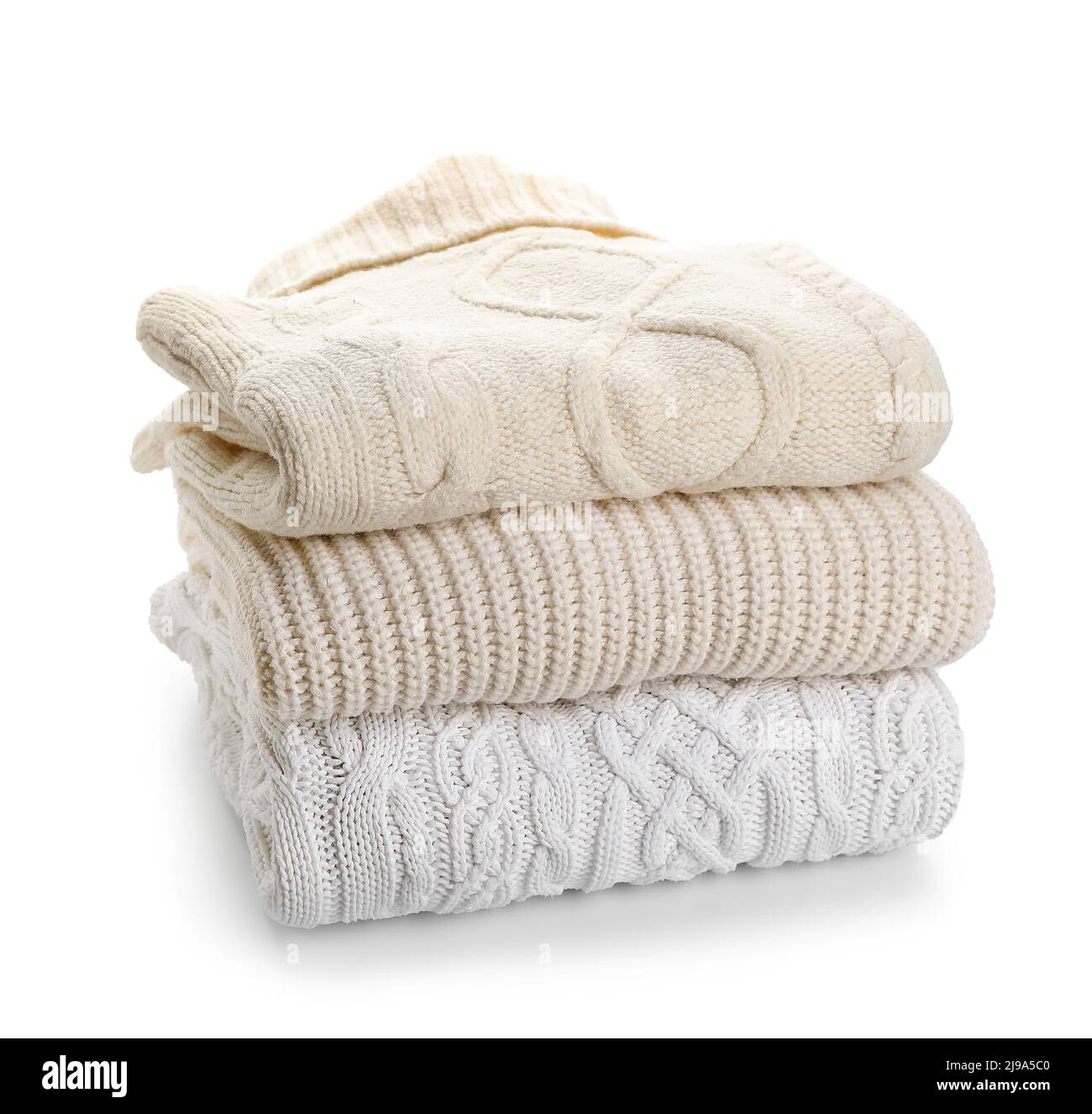 Stack of warm sweaters on white background Stock Photo - Alamy