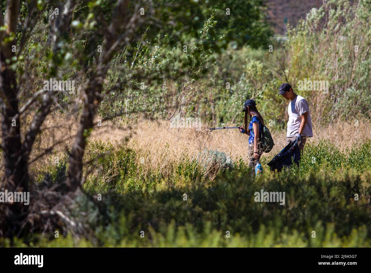 Sparks, United States. 21st May, 2022. Two people gather trash with a ...