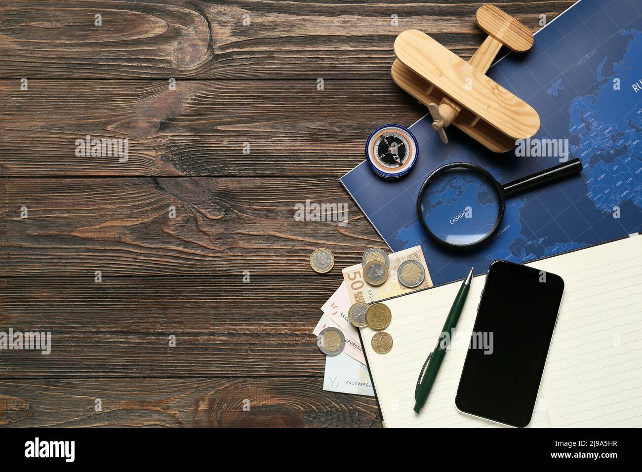 Guide's belongings with airplane on dark wooden background Stock Photo ...