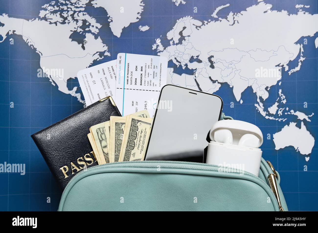 Bag with guide's belongings on world map Stock Photo - Alamy