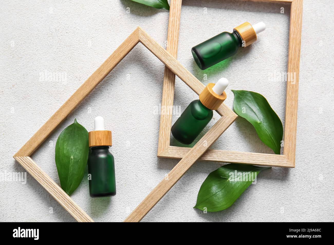 Composition with bottles of natural serum, empty picture frames and ...