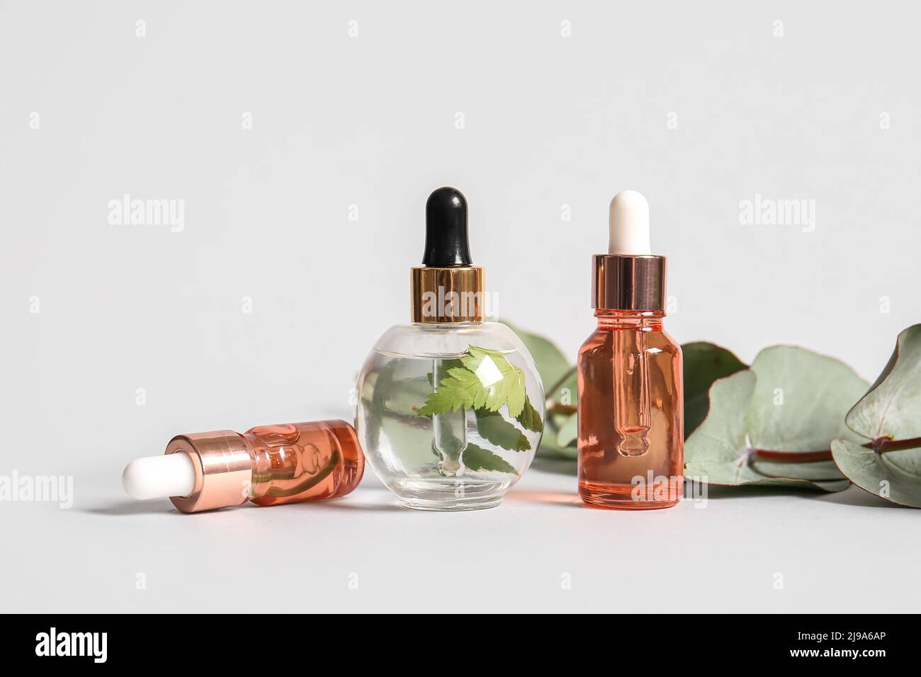 Bottles of natural serum on white background Stock Photo - Alamy