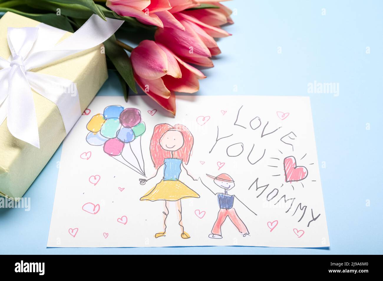 Picture with text LOVE YOU MOMMY, tulips and gift box on blue ...