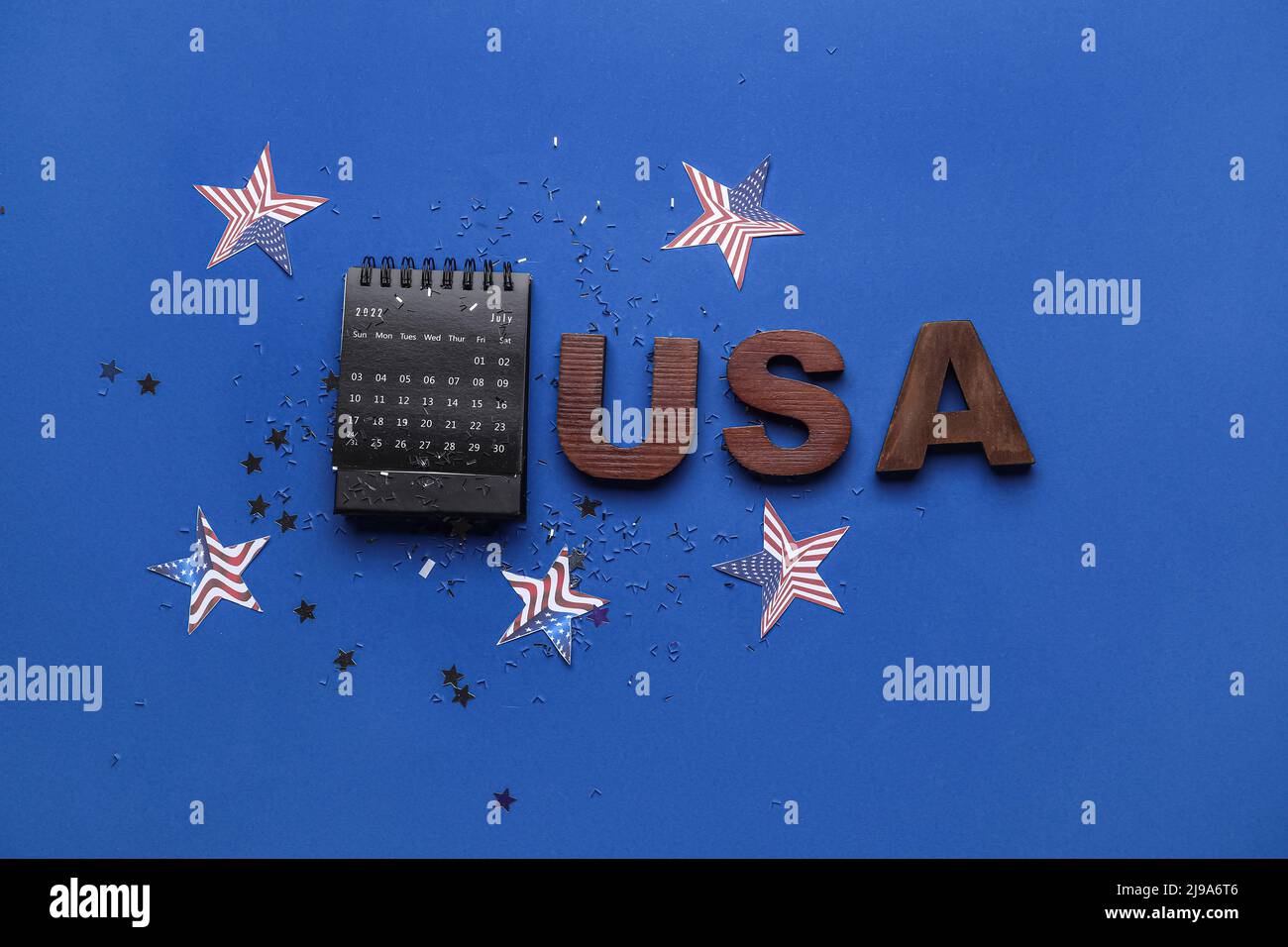 Calendar with word USA, stars and confetti on blue background ...
