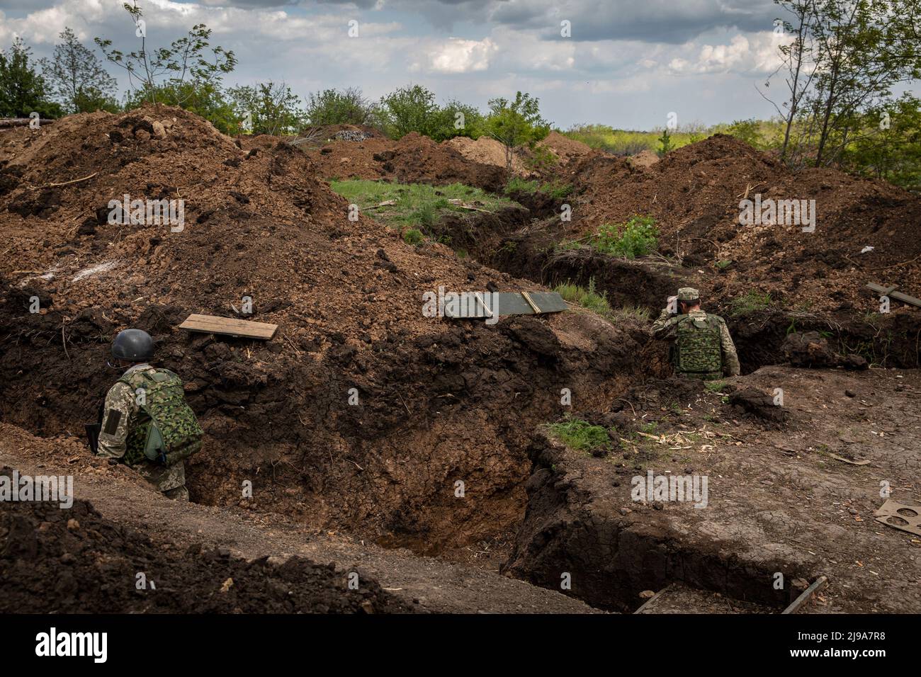 Donetsk, Ukraine. 20th May, 2022. Two soldiers walk in a trench at an ...