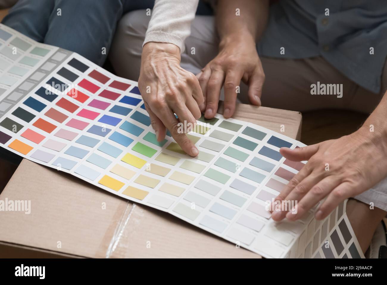 Hands of mature couple choosing wall decoration colors Stock Photo - Alamy