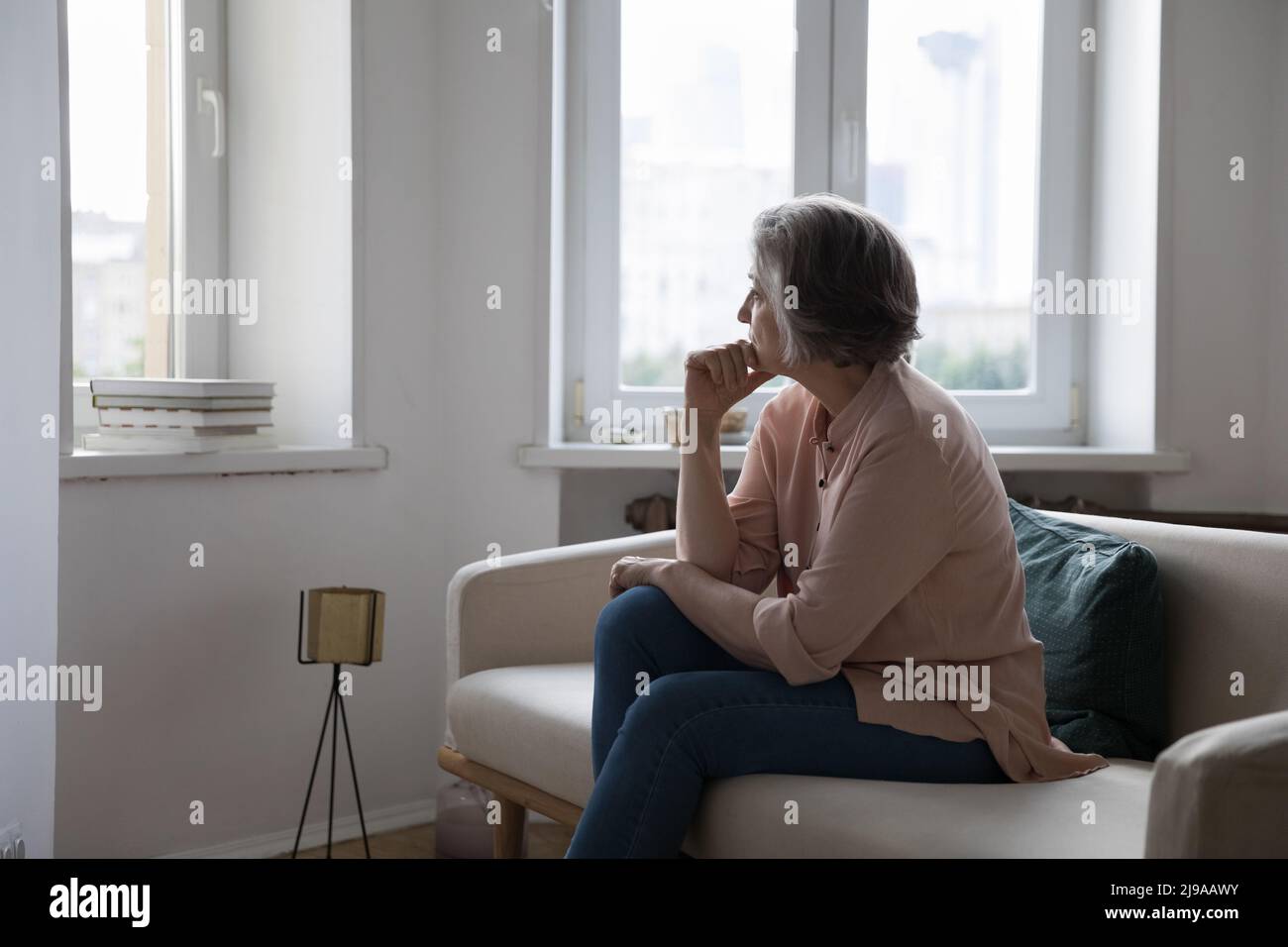 Sad lonely mature grey haired lady looking at window away Stock Photo ...