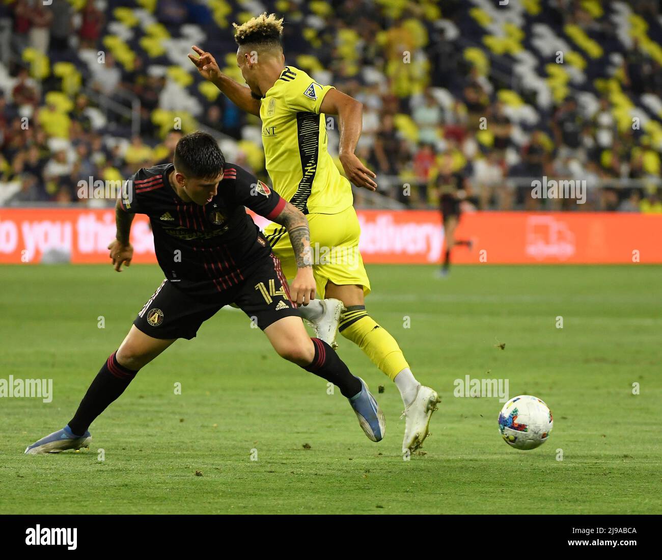 May 21, 2022: Atlanta United midfielder Franco Ibarra (14) pokes the ball away from Nashville SC ...