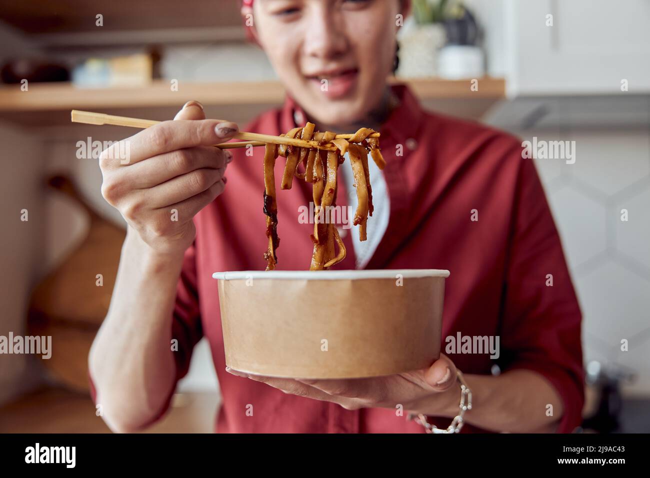 Happy Asian man going to eat noodles with chopsticks Stock Photo - Alamy