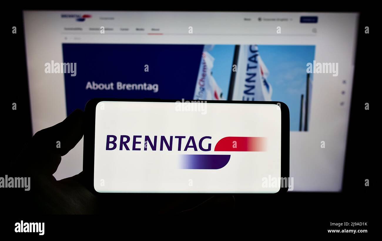 Person holding smartphone with logo of German chemical company Brenntag ...