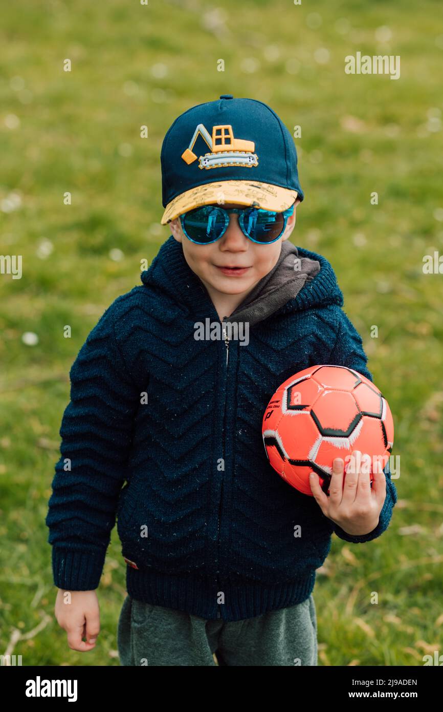 Child holding ball face hi-res stock photography and images - Alamy
