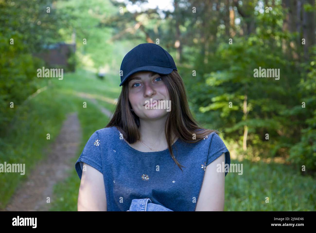 Young female student with blue eyes, folder and backpack on nature ...