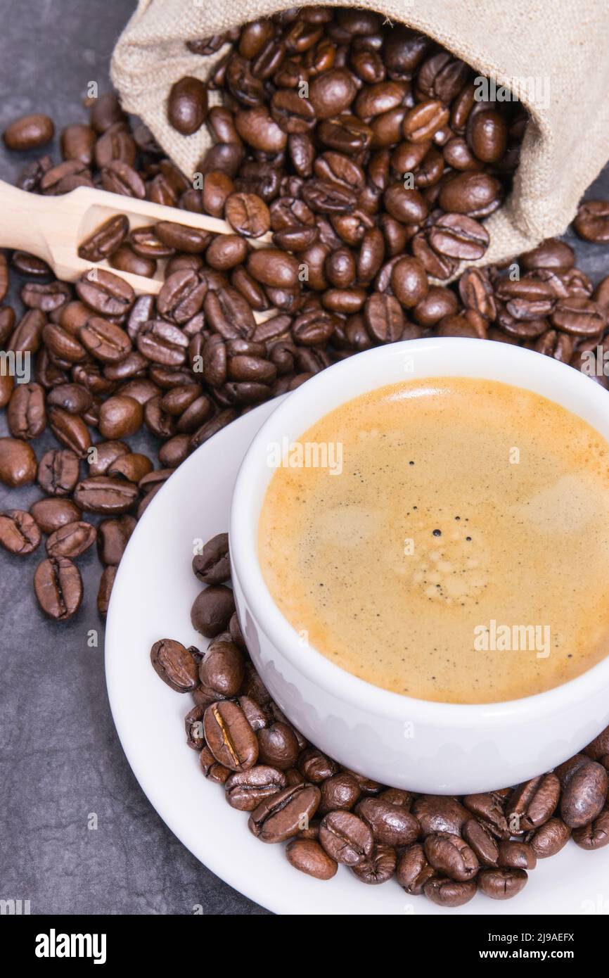 Coffee in white glass cup and roasted fragrant coffee beans Stock Photo ...