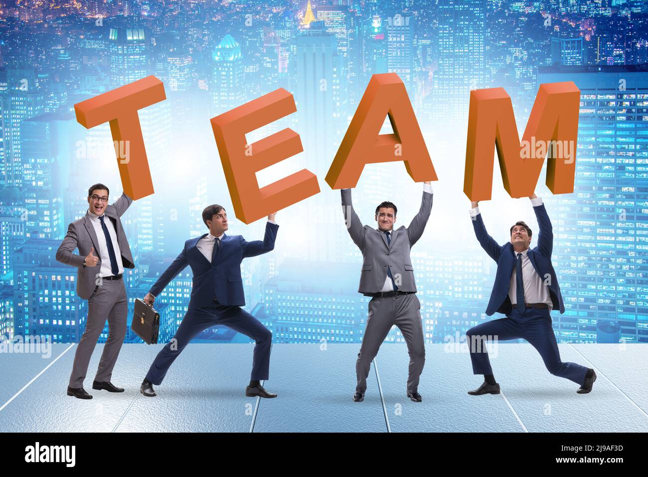 Teamwork concept with the people carrying team letters Stock Photo - Alamy