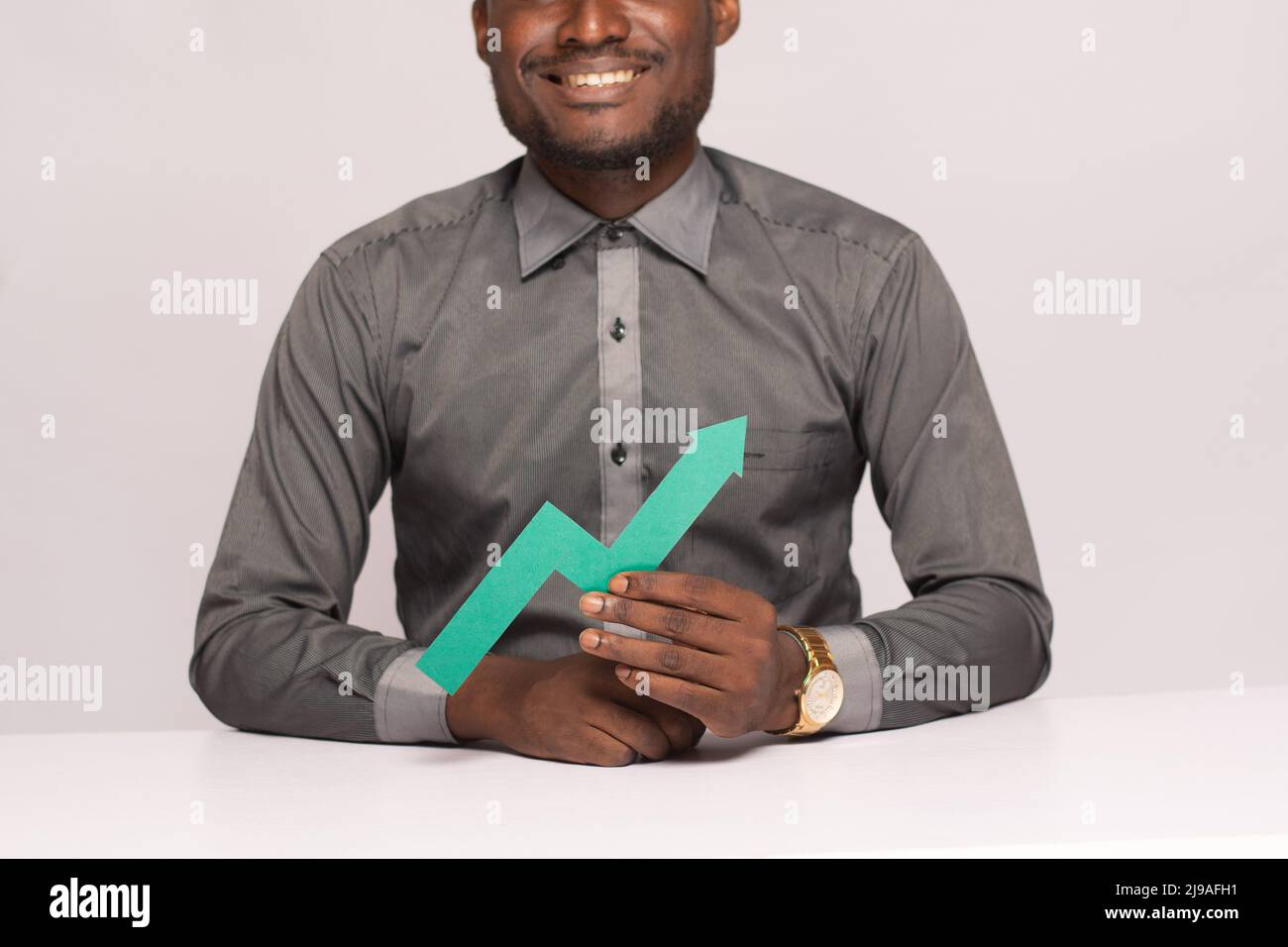 black business man holding a graph line pointing up Stock Photo - Alamy