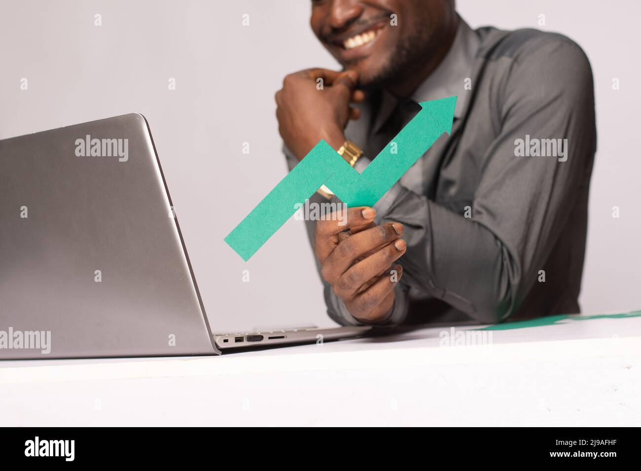 black businessman holding a graph line pointing up Stock Photo - Alamy