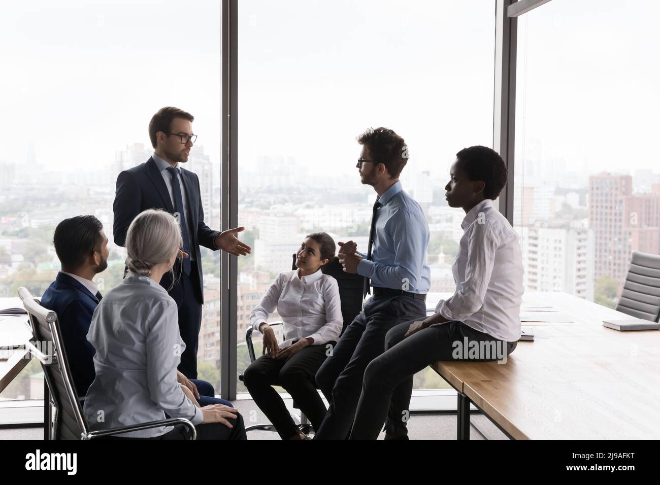 Team leader lead corporate meeting with multiethnic teammates in office ...