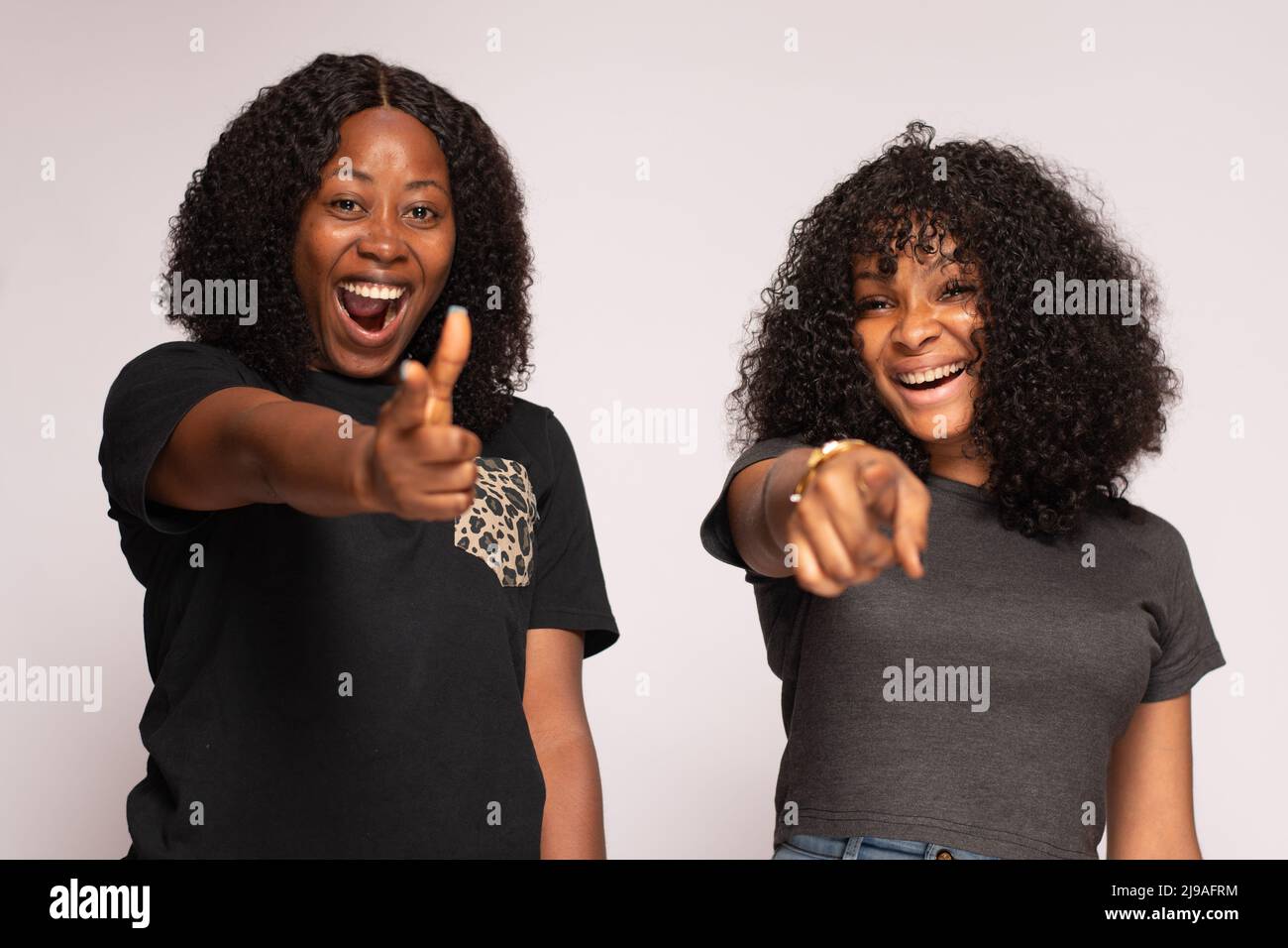 excited black girls excitedly pointing towards the viewer Stock Photo ...