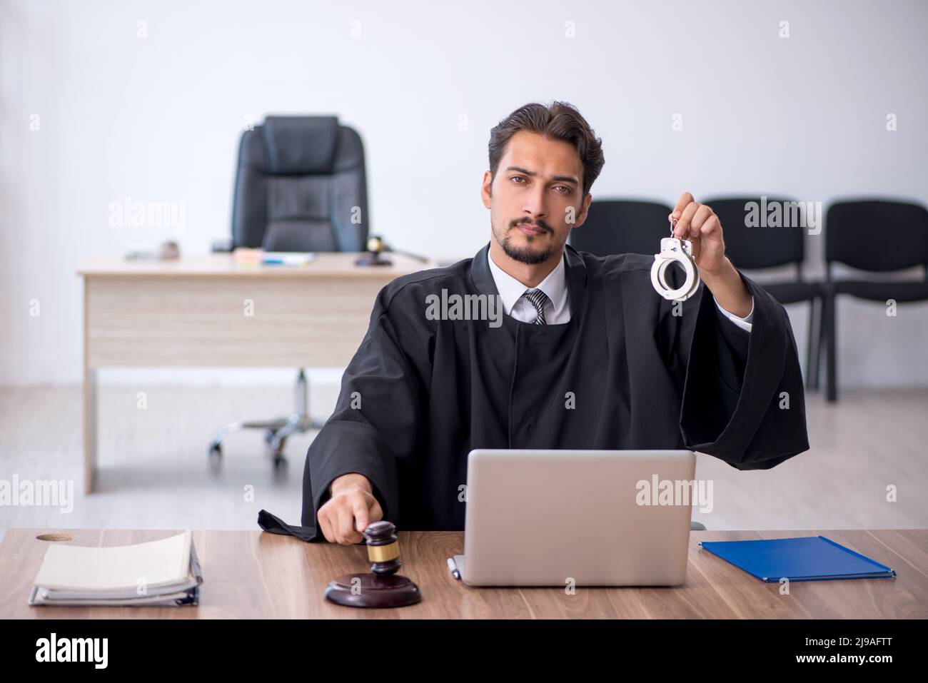Young judge working in the courthouse Stock Photo - Alamy