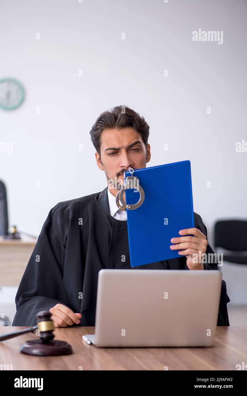 Young judge working in the courthouse Stock Photo - Alamy