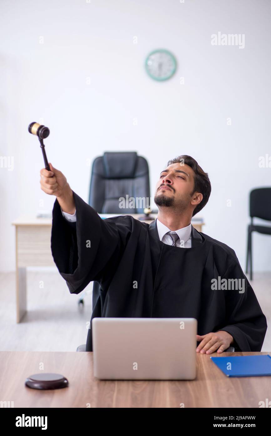 Young judge working in the courthouse Stock Photo - Alamy