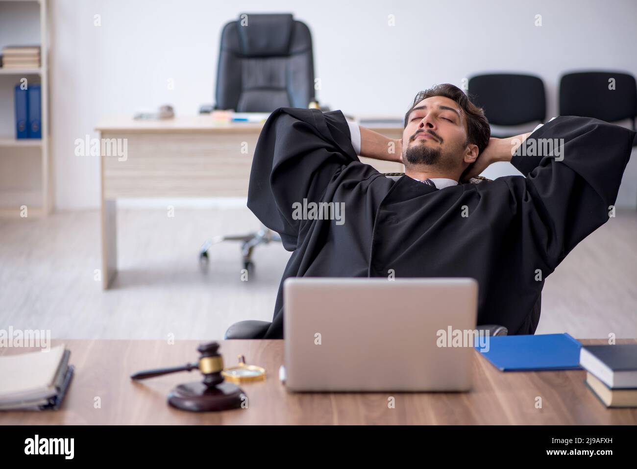 Young judge working in the courthouse Stock Photo - Alamy