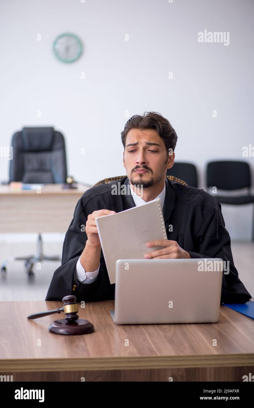 Young judge working in the courthouse Stock Photo - Alamy
